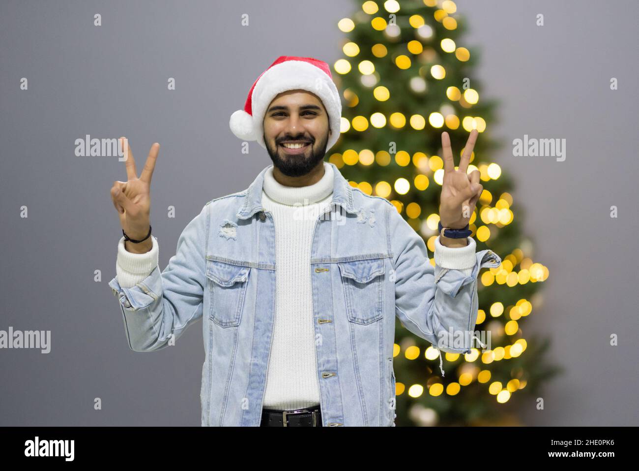 Happy indian man in jumper hi-res stock photography and images - Alamy