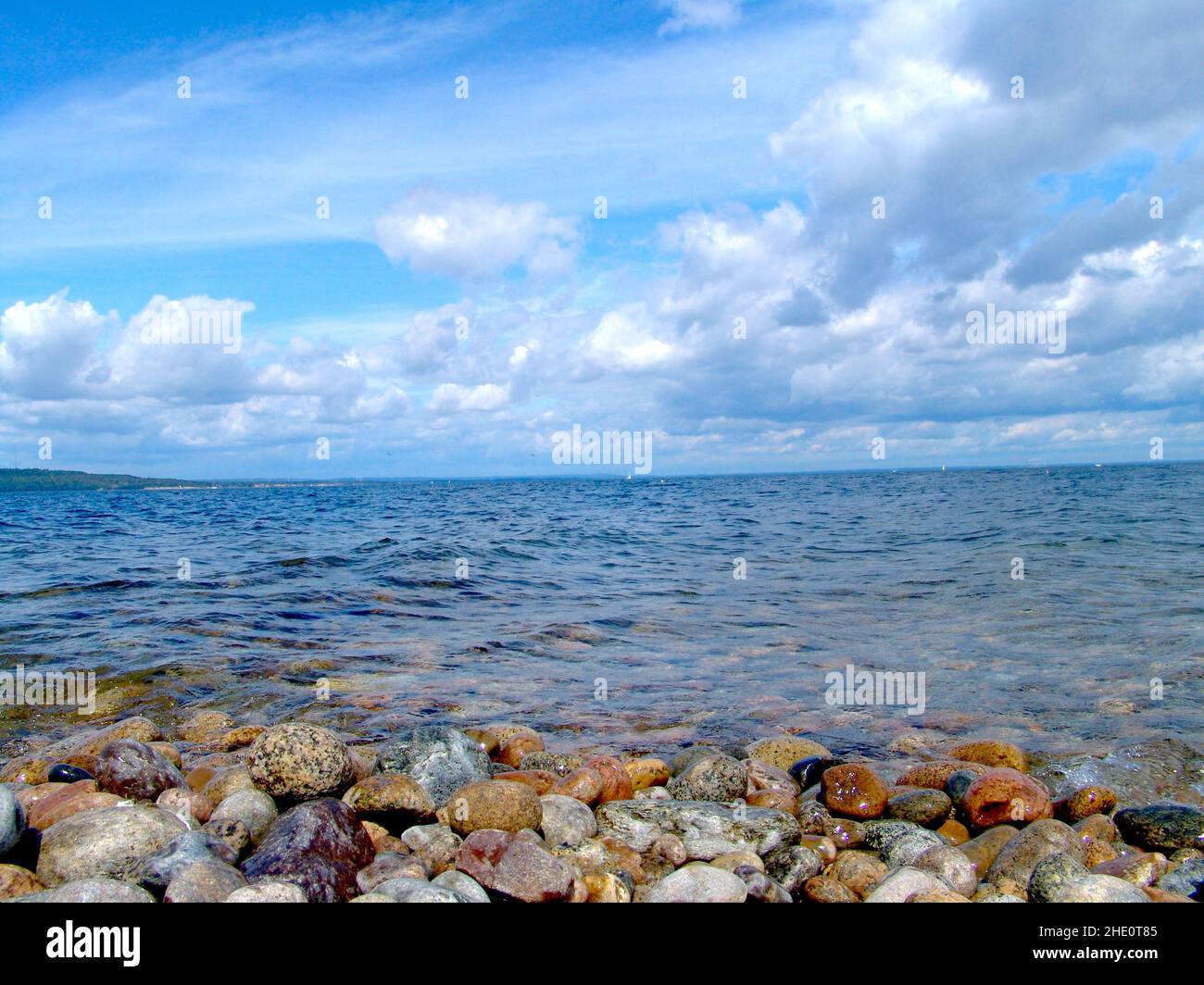 Tranquil scenery of a blue sea under a cloudy sky Stock Photo - Alamy