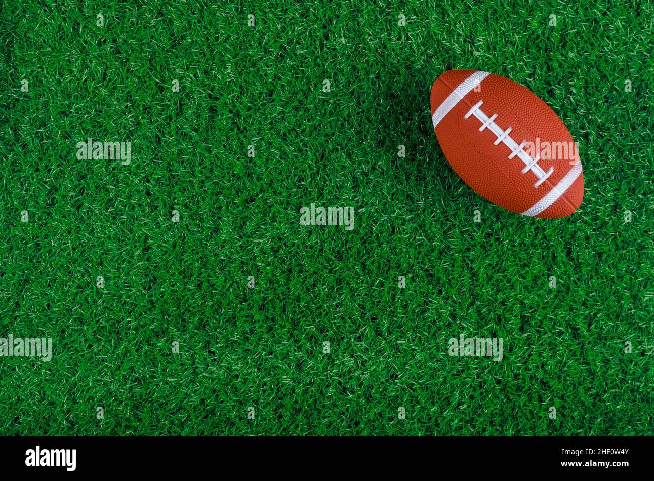 Green grass sports field with american football ball. Football game ...