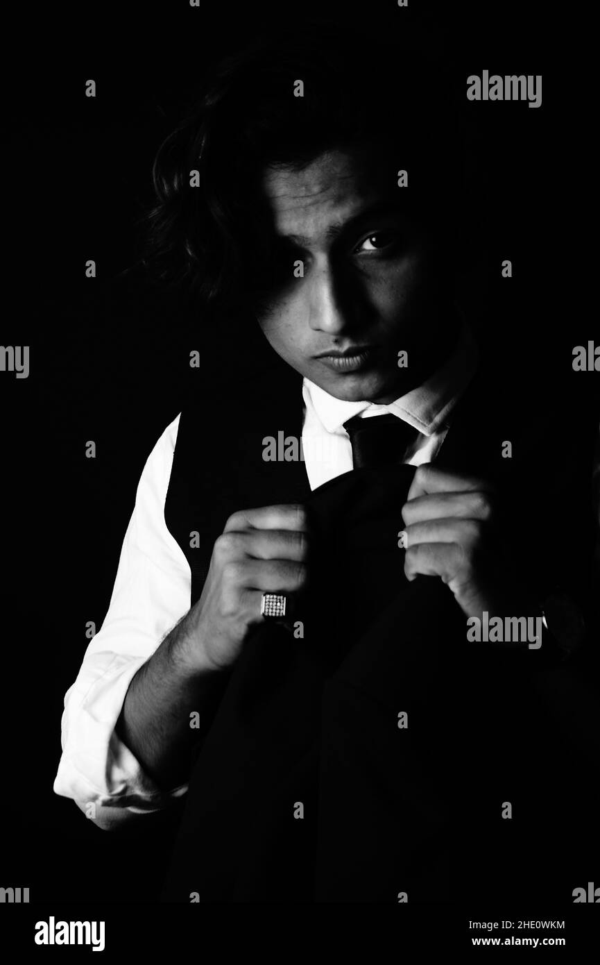 Vertical shot of an attractive Indian gentleman posing in classic ...
