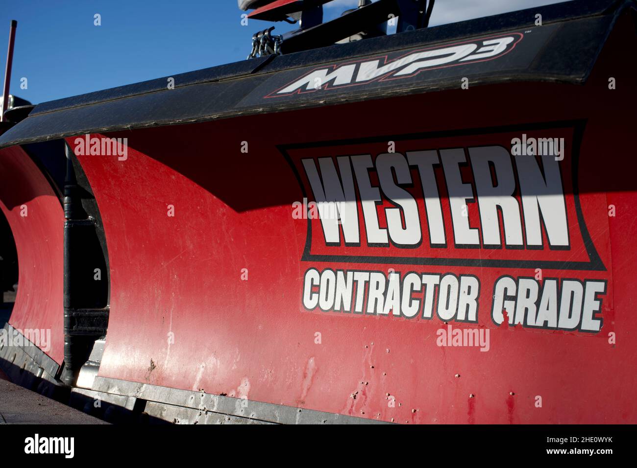 Closeup of a snow plow blade with writing "Western contractor grade ...