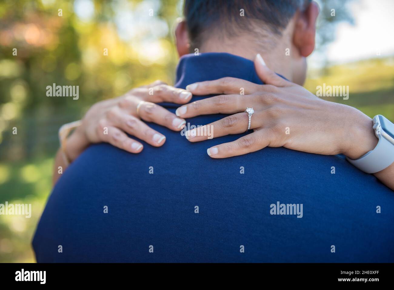Indian female hands over the shoulder of her husband Stock Photo - Alamy