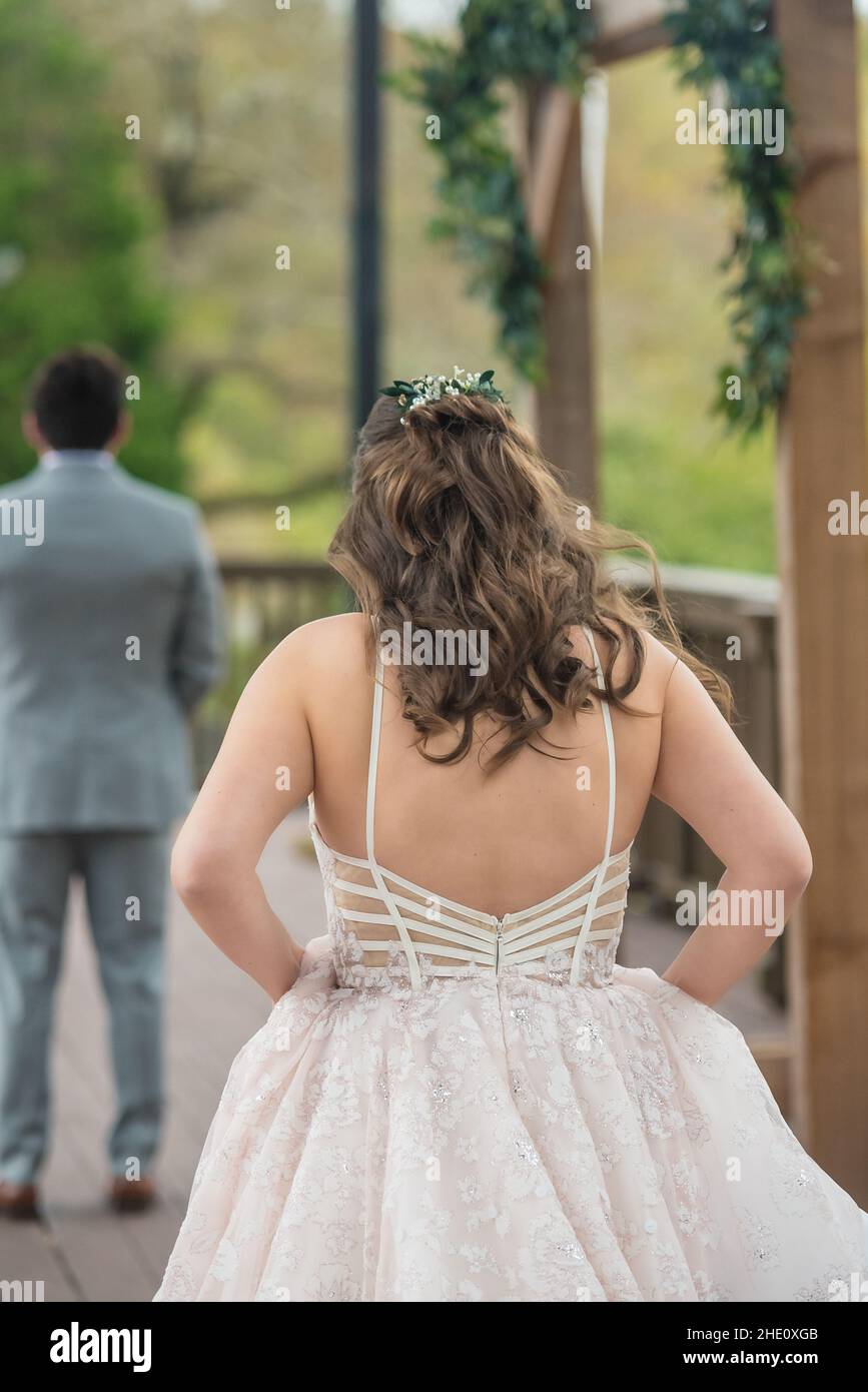 Selective of a bride going after the groom Stock Photo - Alamy