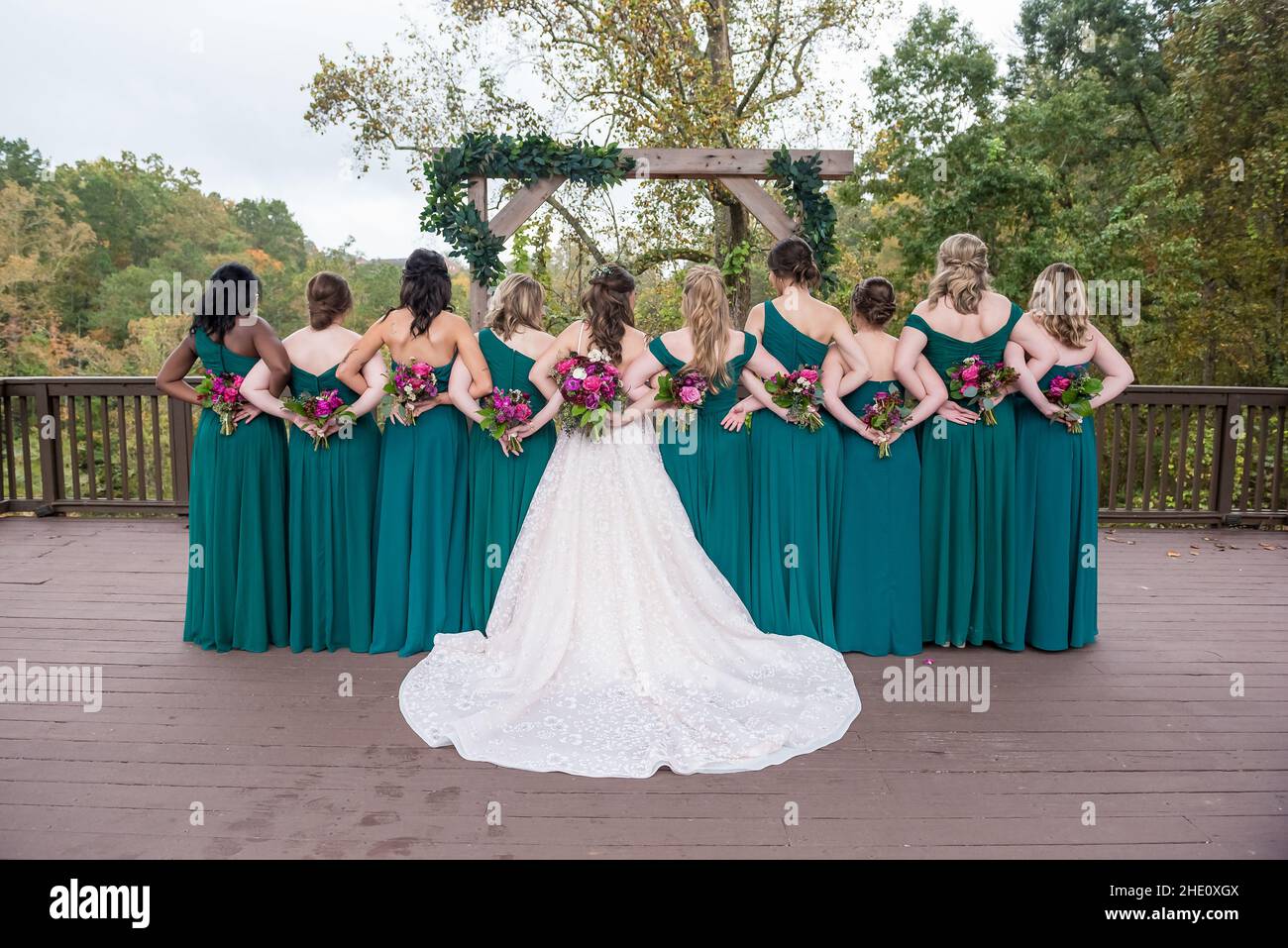 Bride with her bridesmen with intertwined hands Stock Photo - Alamy