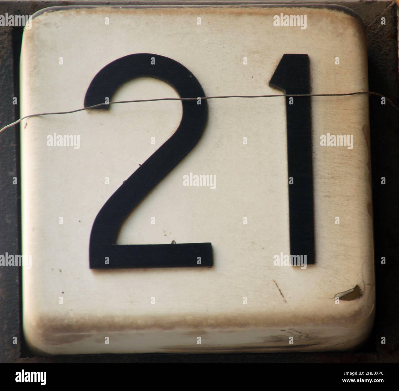 Closeup of the 21 building number plate on a wall in the daylight Stock ...