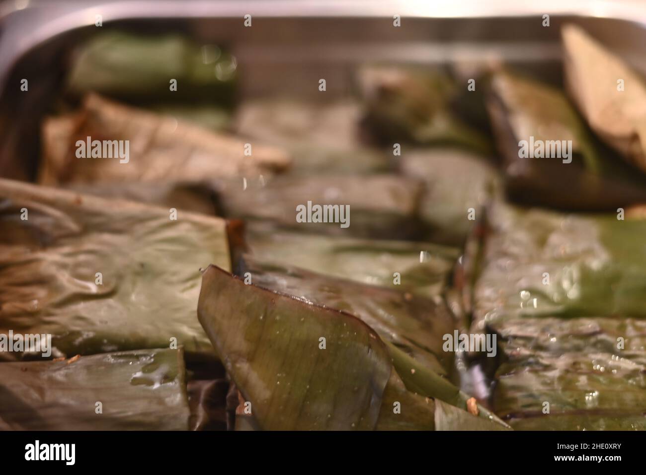 Bhetki Macher Paturi in which the bhatki fish cooked in a banana leaf ...
