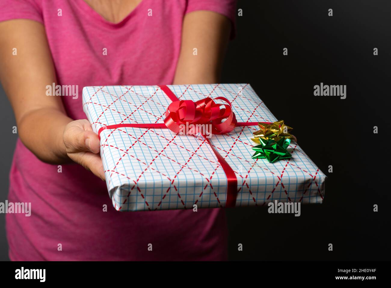 Woman hands a wrapped present- selective focus Stock Photo - Alamy