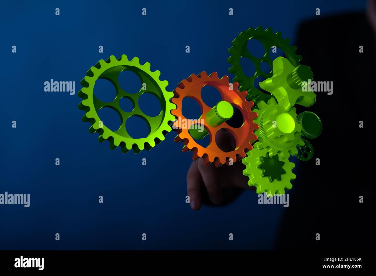 Male's hand holding an illustration of green metallic gears and cogs ...