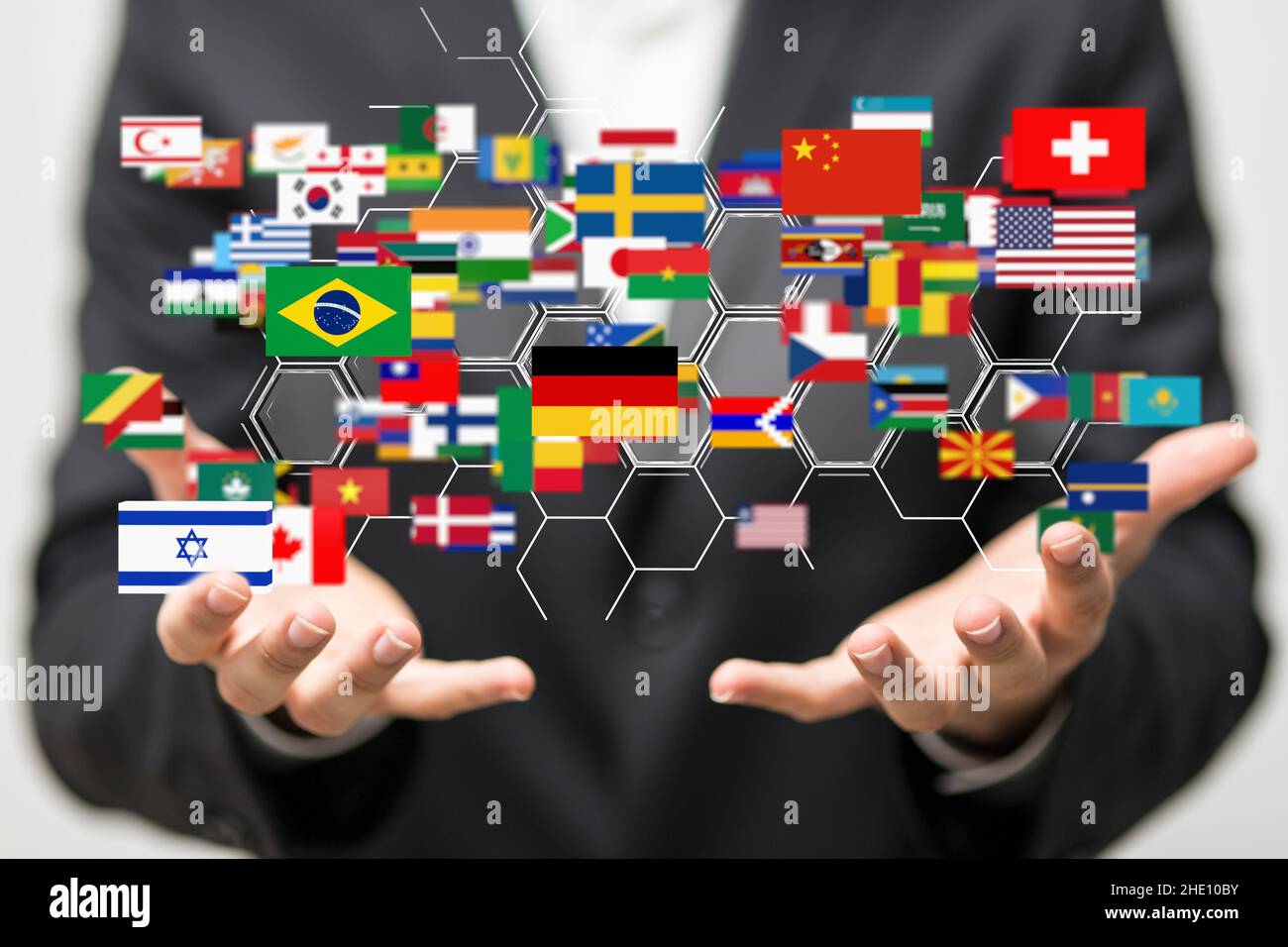 Male's hands holding a bunch of illustrated flags of different ...