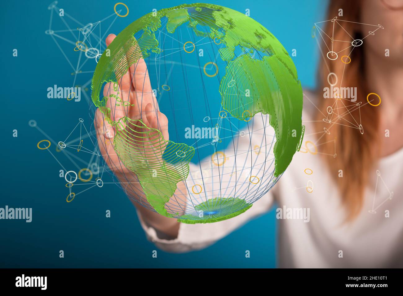 Female's hand pointing to an illustration of global network concept ...