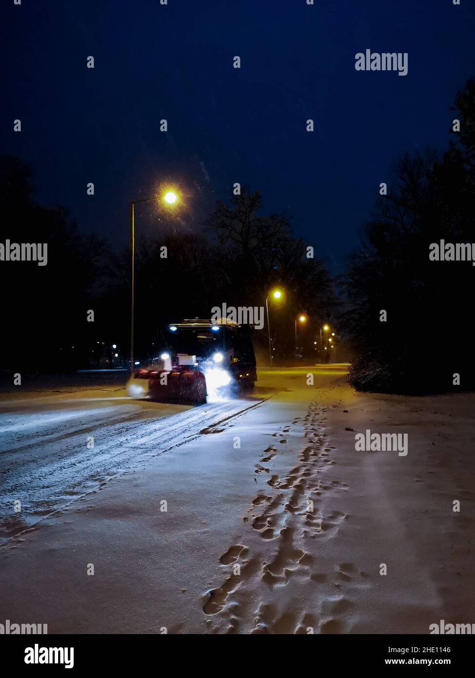 Big snow plow ride at dark snowy morning through the street Stock Photo ...