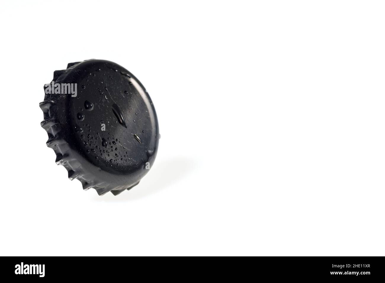 Close up view of black metal cap with drops isolated on white ...
