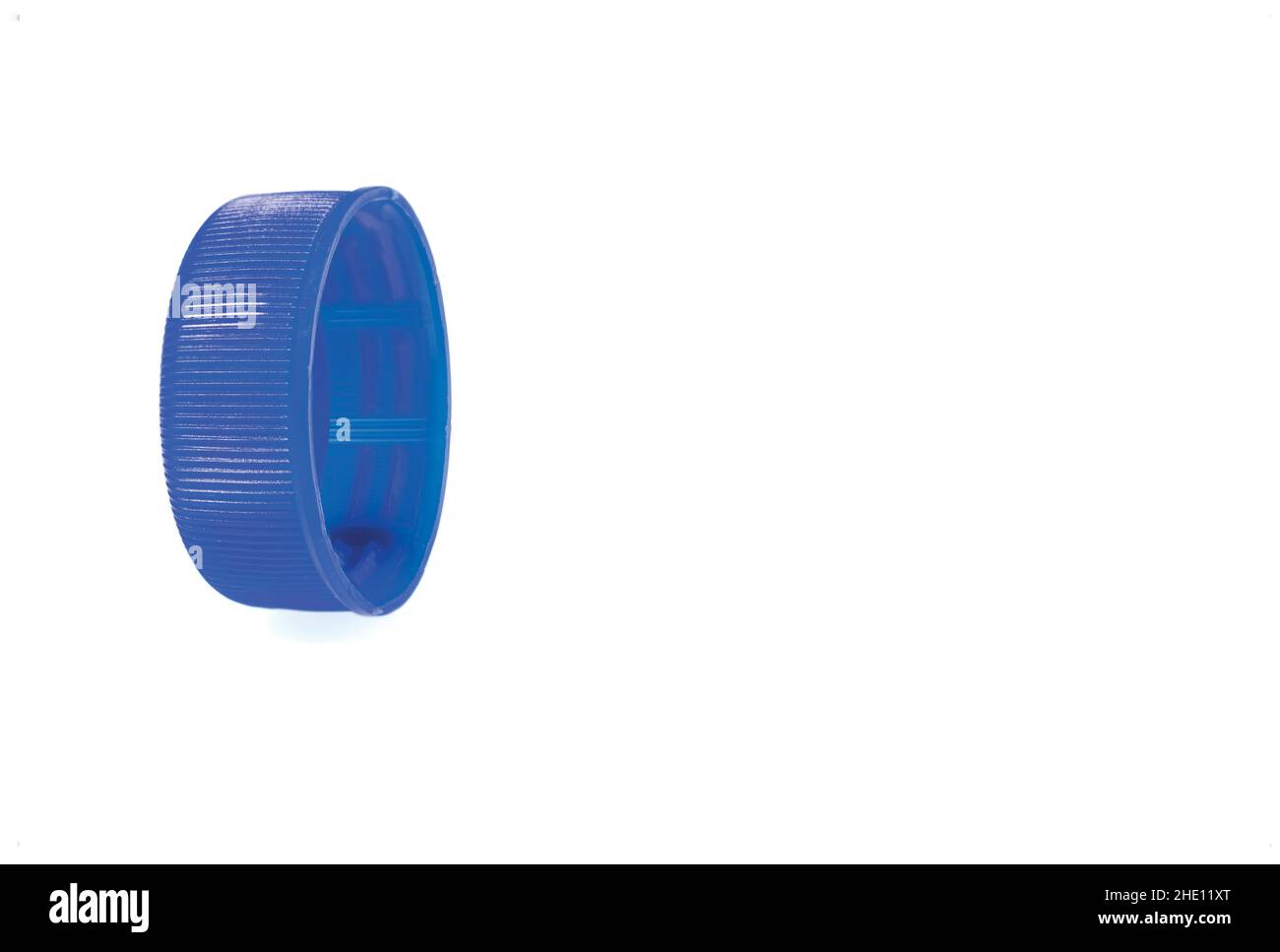 Close up side view of a blue plastic cap isolated on white background ...