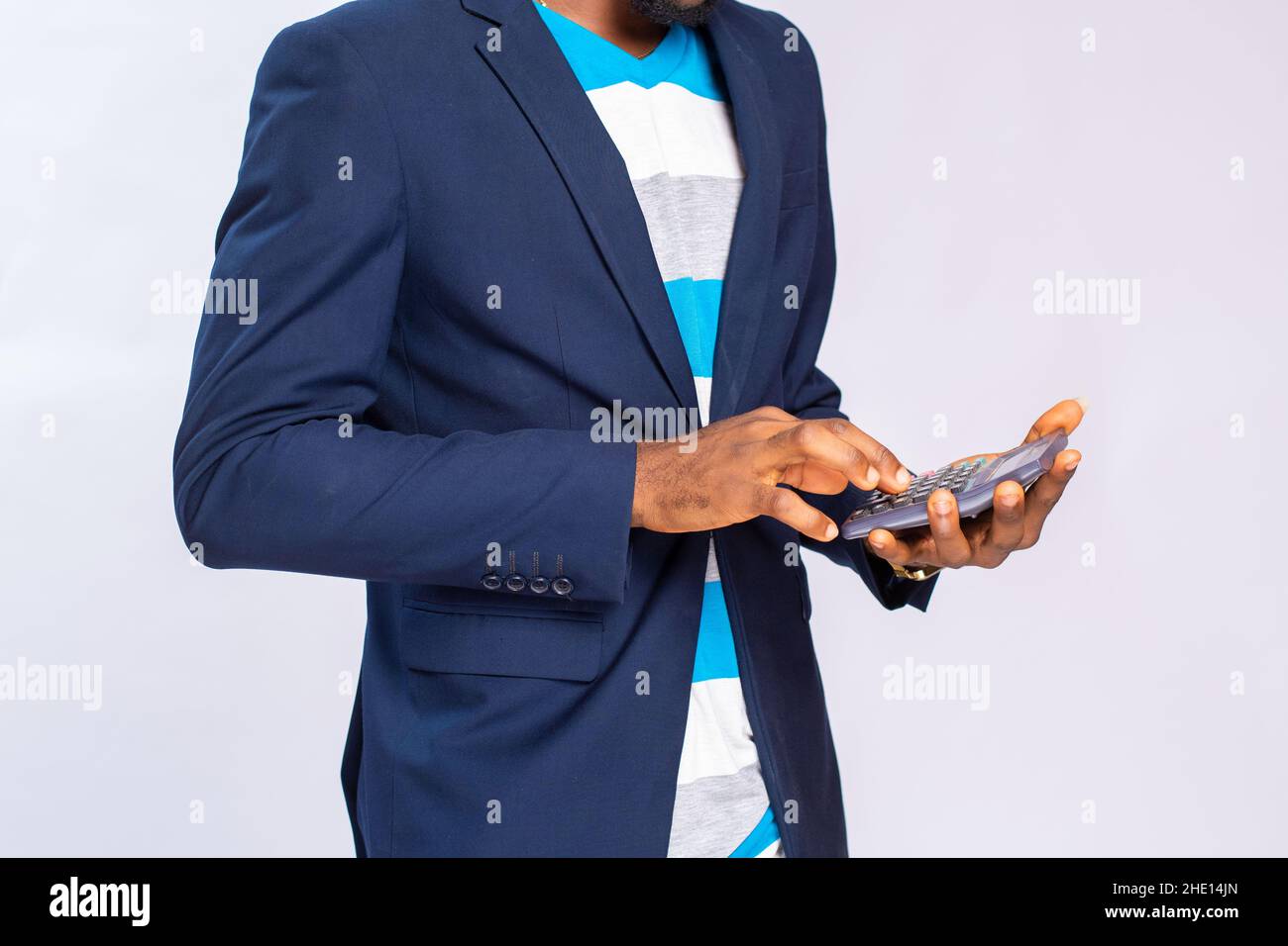 African Businessman uses a calculator for calculations Stock Photo - Alamy