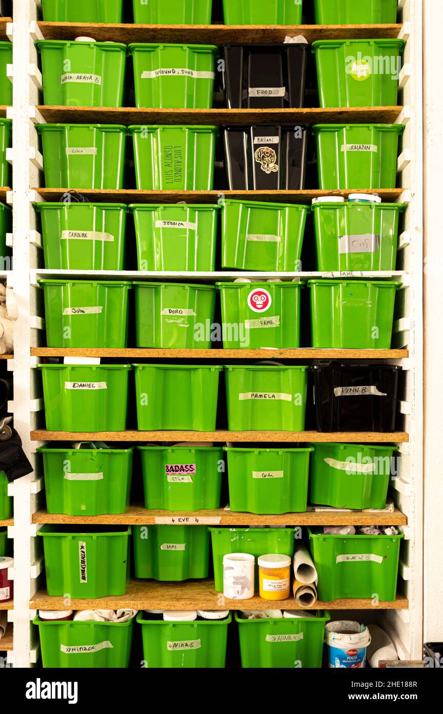 Vertical shot of organized green and black plastic boxes organized on ...