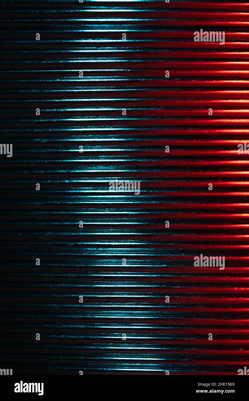 Closeup of coiled metal spring rings in a compressed state in red and ...
