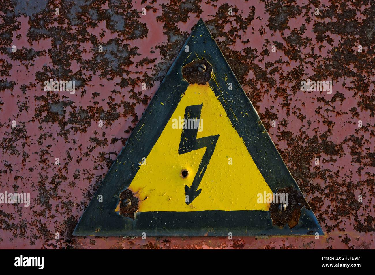 Old, rusty warning about danger and high voltage in form lightning ...