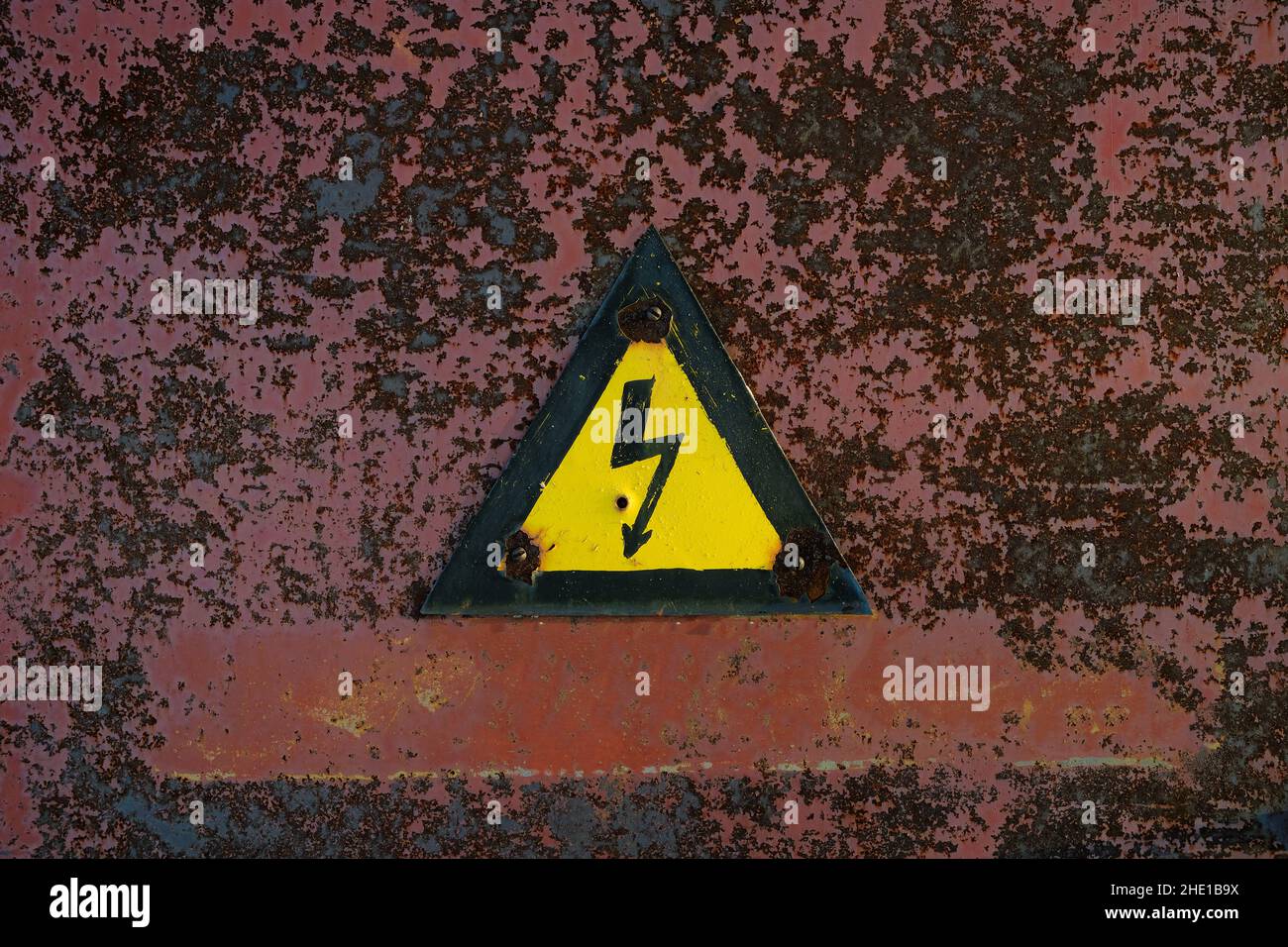 Old, rusty warning about danger and high voltage in form lightning ...