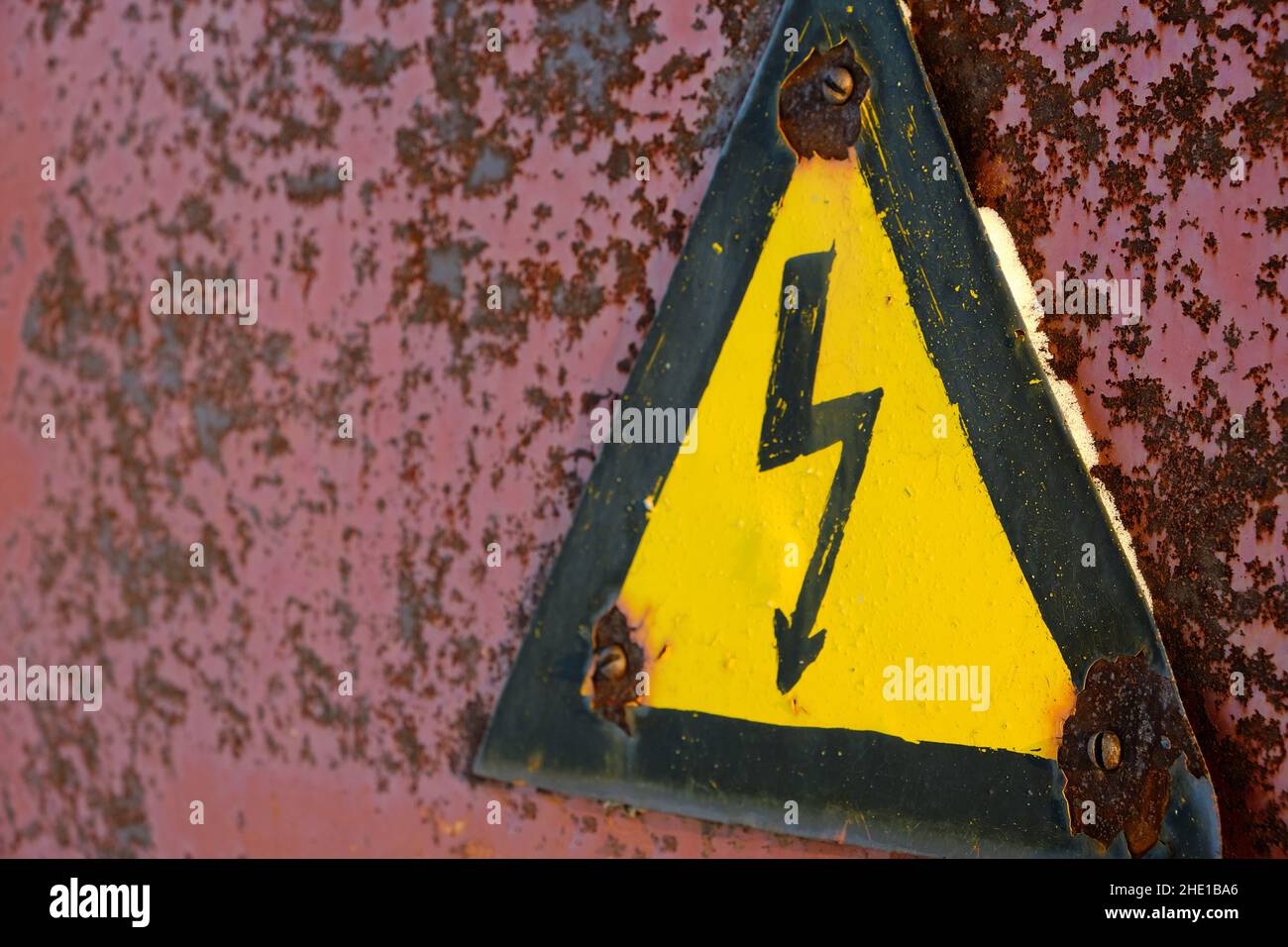 Old, rusty warning about danger and high voltage in form lightning ...