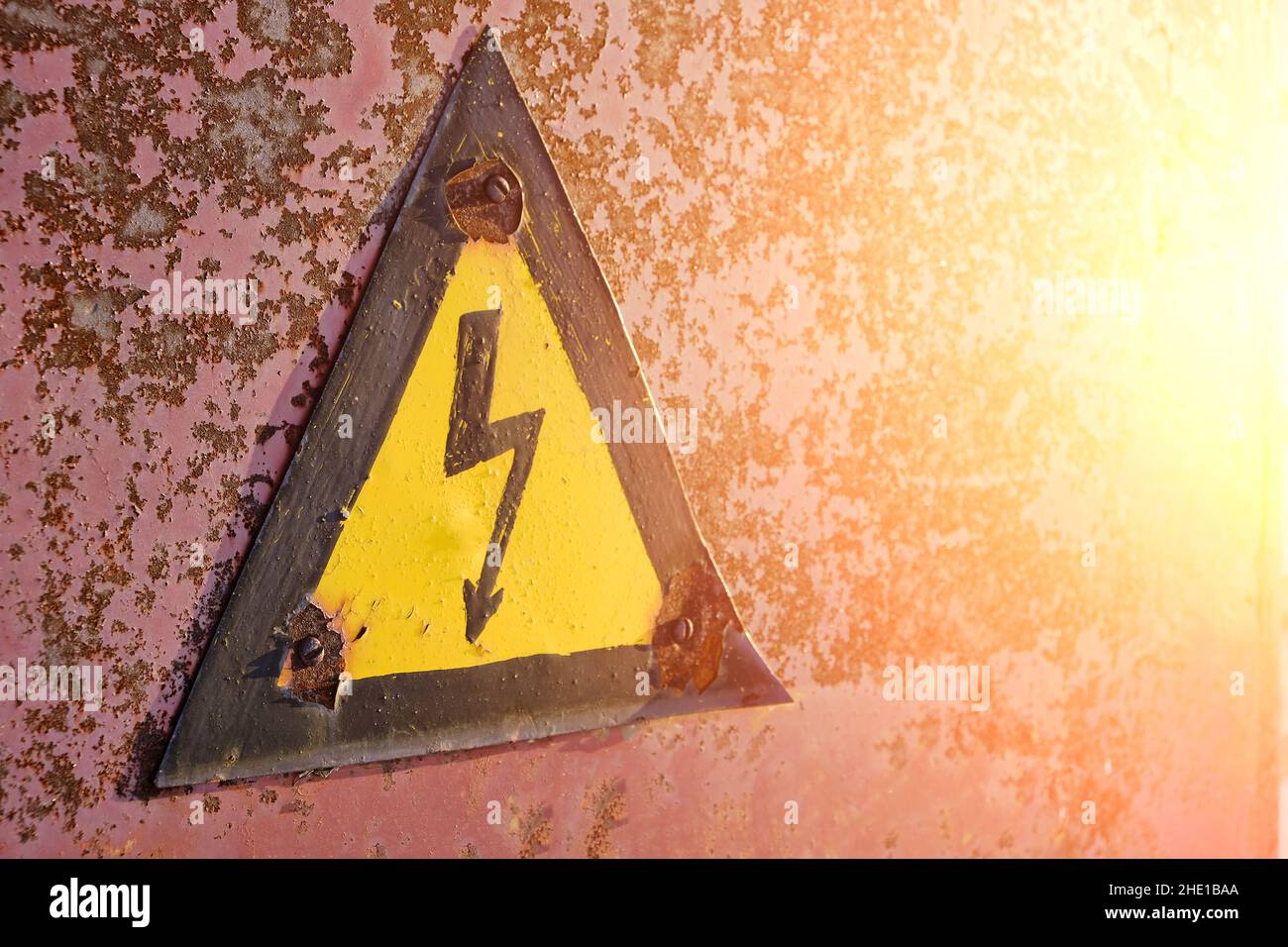 Old, rusty warning about danger and high voltage in form lightning ...