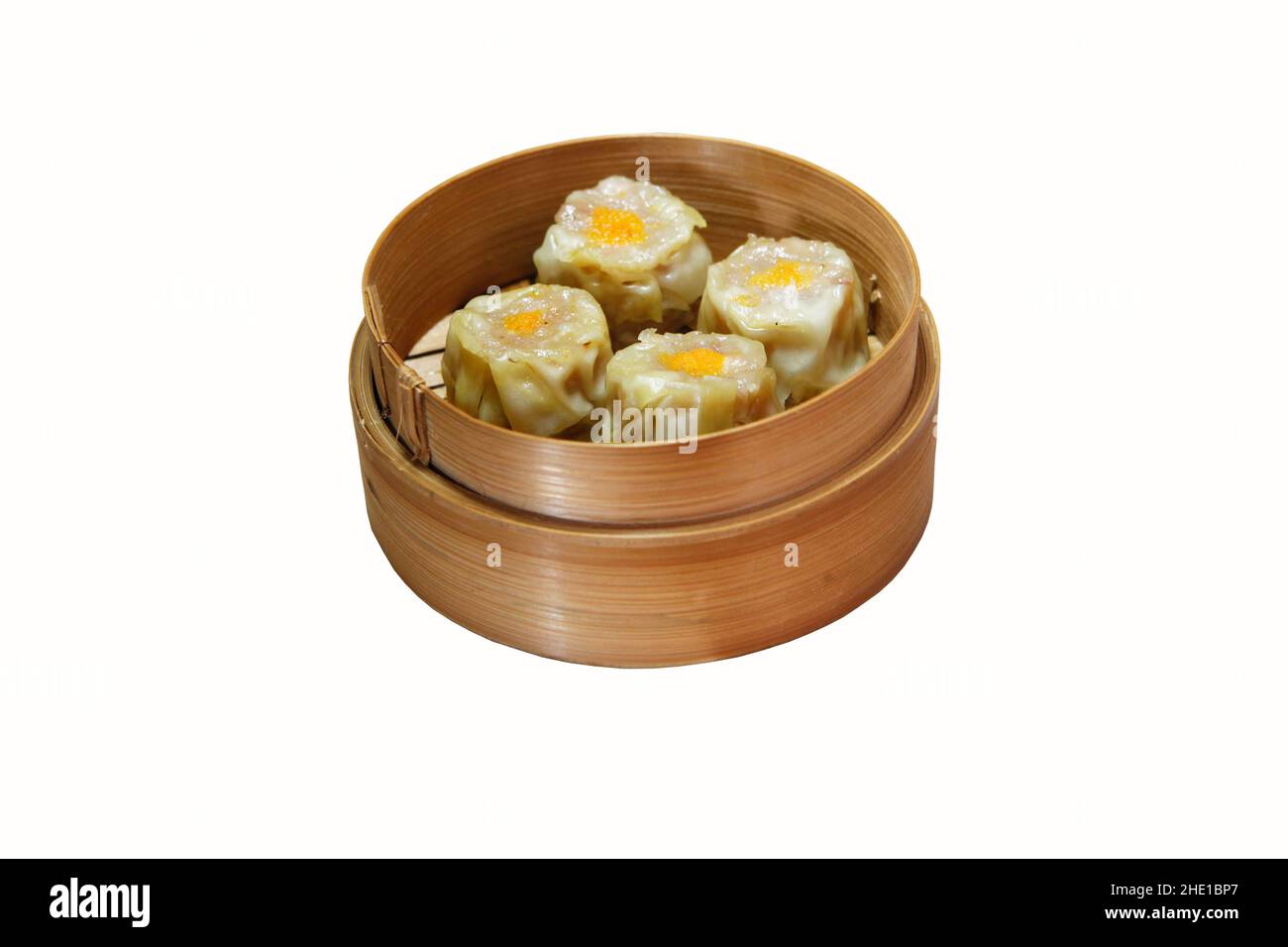 various types of dim sum in a bamboo container on a white background ...