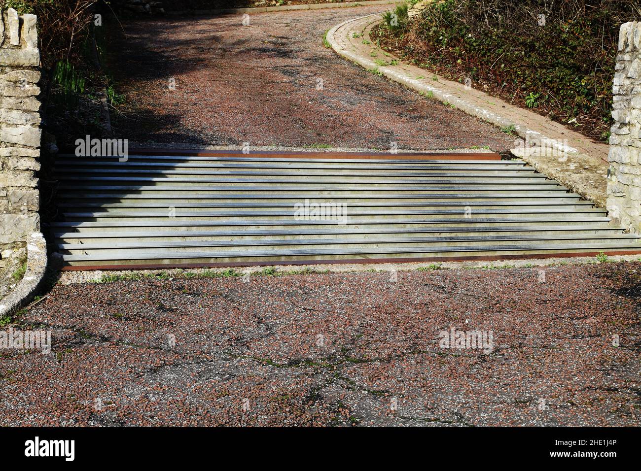 A well constructed cattle grid on a driveway protecting the house ...