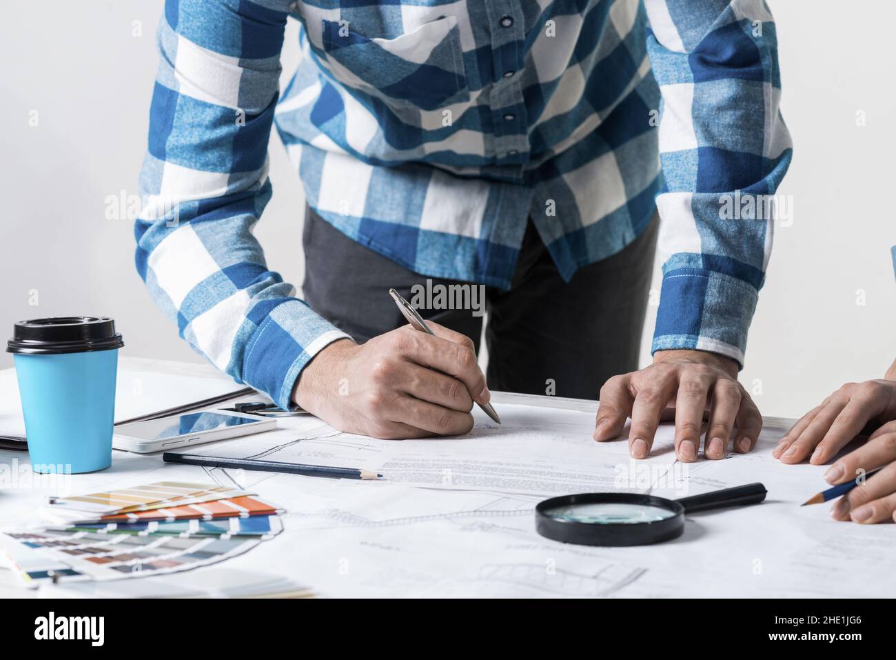 Man writing with pen on technical drawing Stock Photo - Alamy