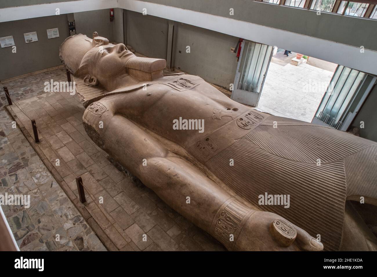 A giant statue of Rameses II, an Egyptian pharaoh lies in the museum ...