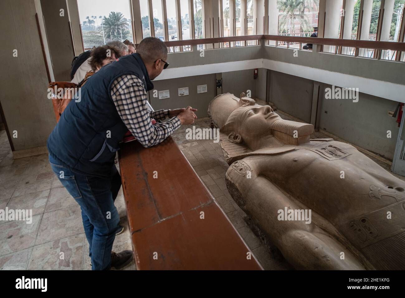 A giant statue of Rameses II, an Egyptian pharaoh lies in the museum ...