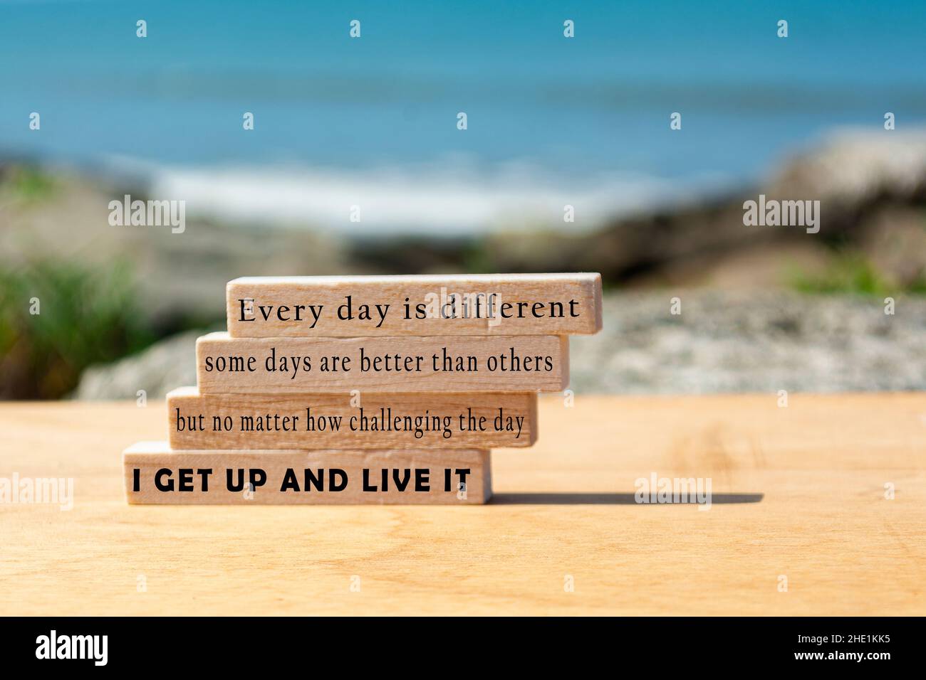 Motivational and inspirational quote on wooden block with blurred ...