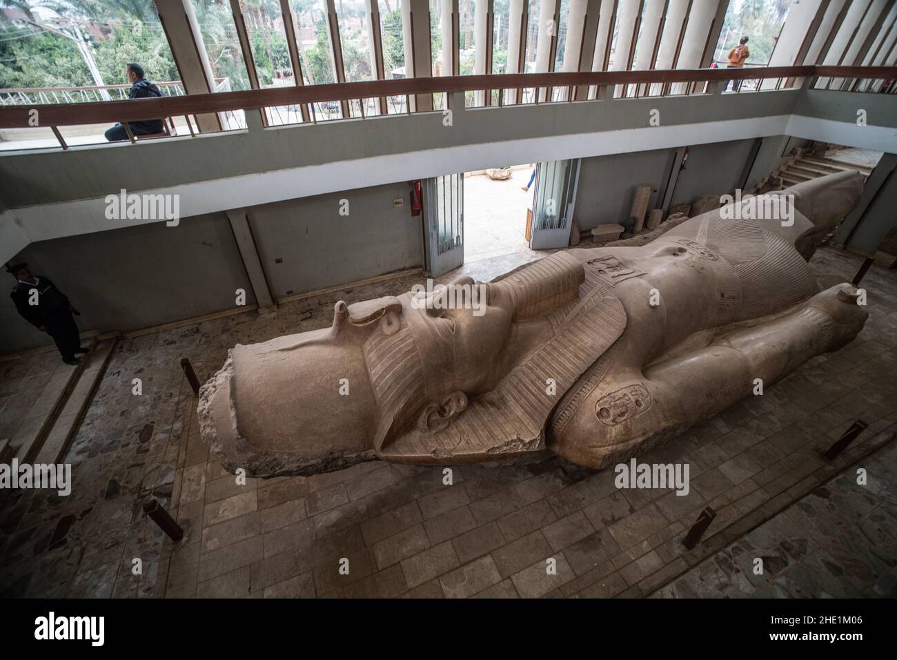 A giant statue of Rameses II, an Egyptian pharaoh lies in the museum ...