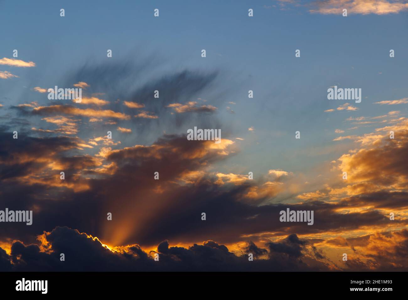 The setting sun lighting up the cloud cover Stock Photo - Alamy