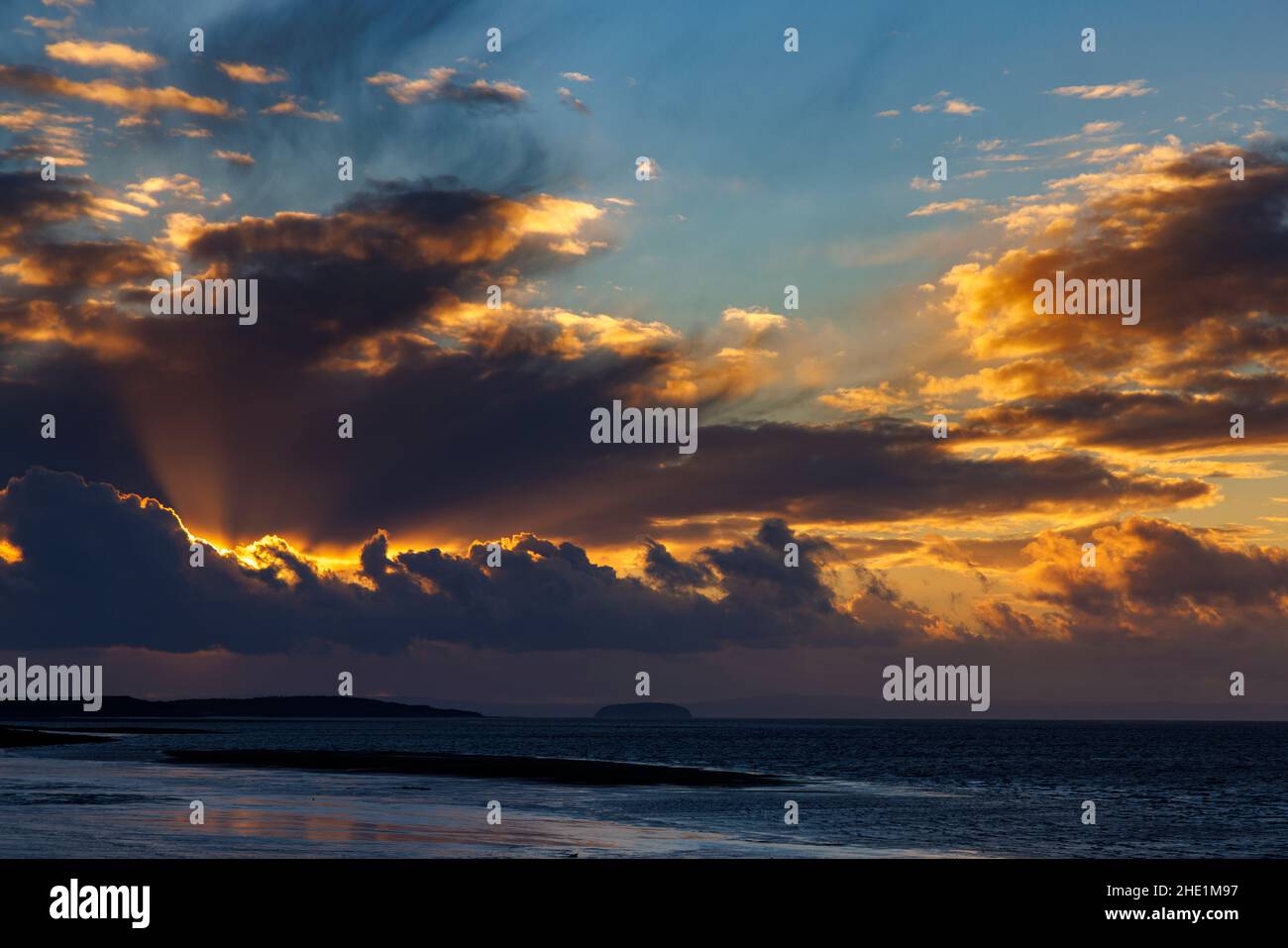 The setting sun lighting up the cloud cover Stock Photo - Alamy