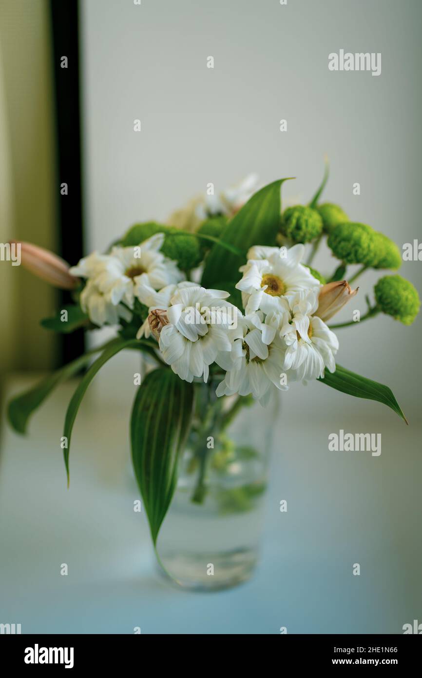 Bouquet of wilted flowers in a vase on a windowsill Stock Photo - Alamy