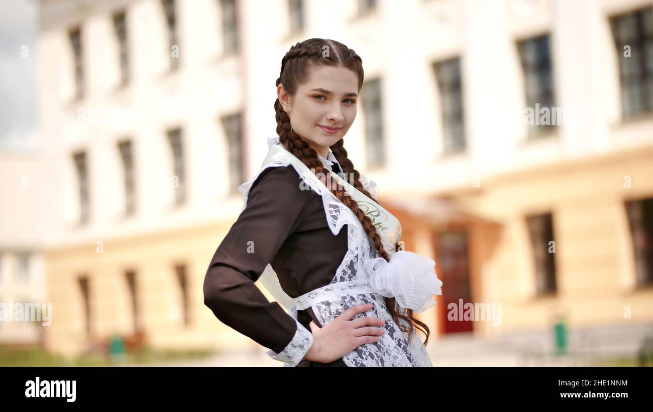 Happy Russian graduate with pigtails posing on graduation day Stock ...