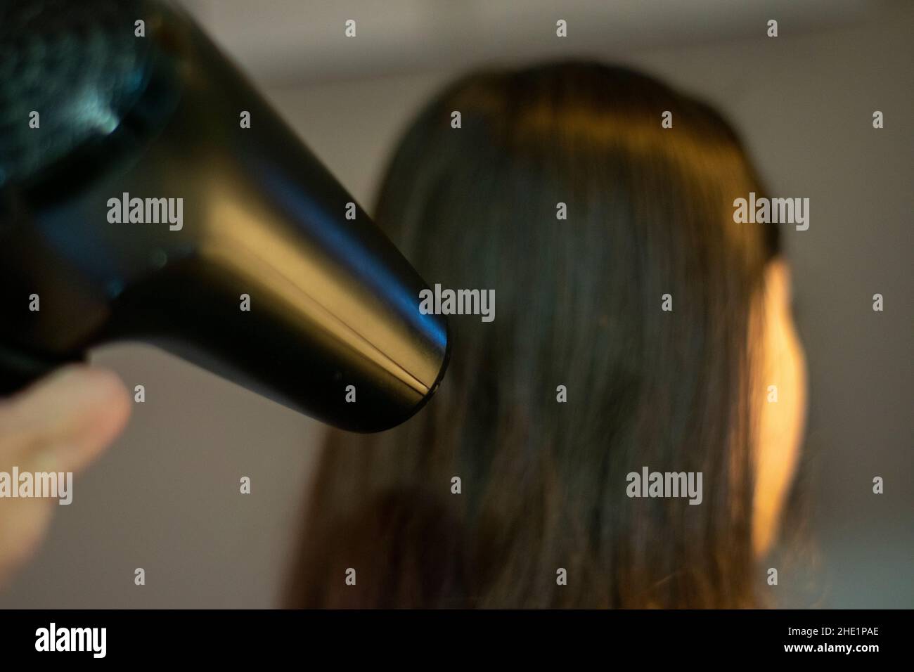 Holding hair dryer after kids bath, taking care of kids, drying hairs ...