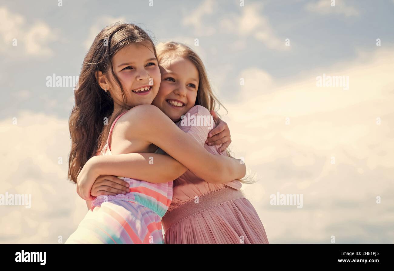 happy children embrace on sky background, family love Stock Photo - Alamy
