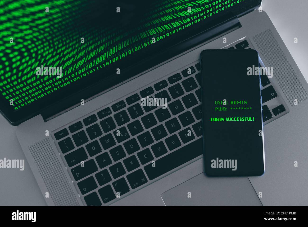 Laptop with green numbers on display. Smartphone displaying successful ...