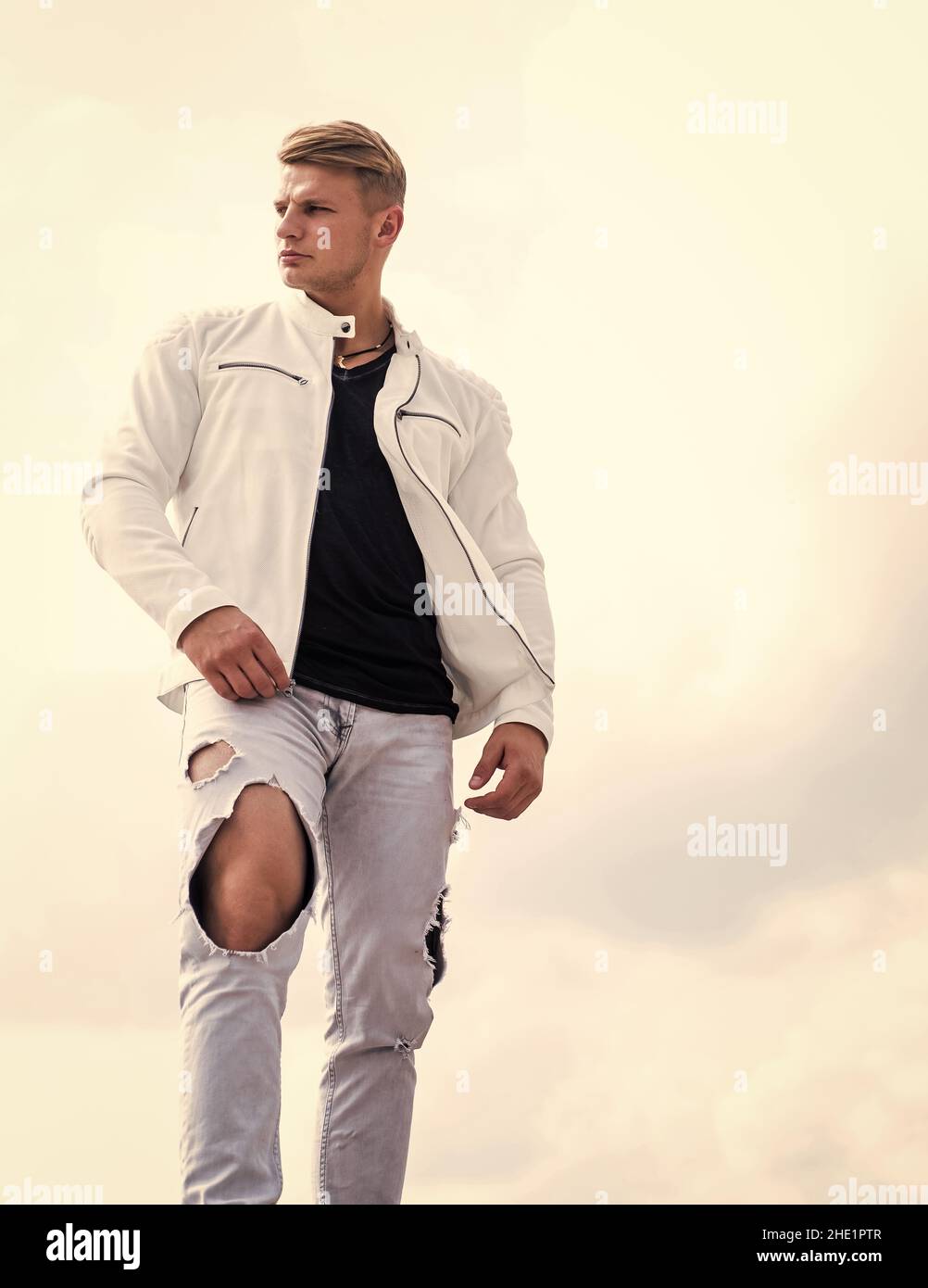 Single young guy in casual fashion wear travel idyllic cloudy sky ...