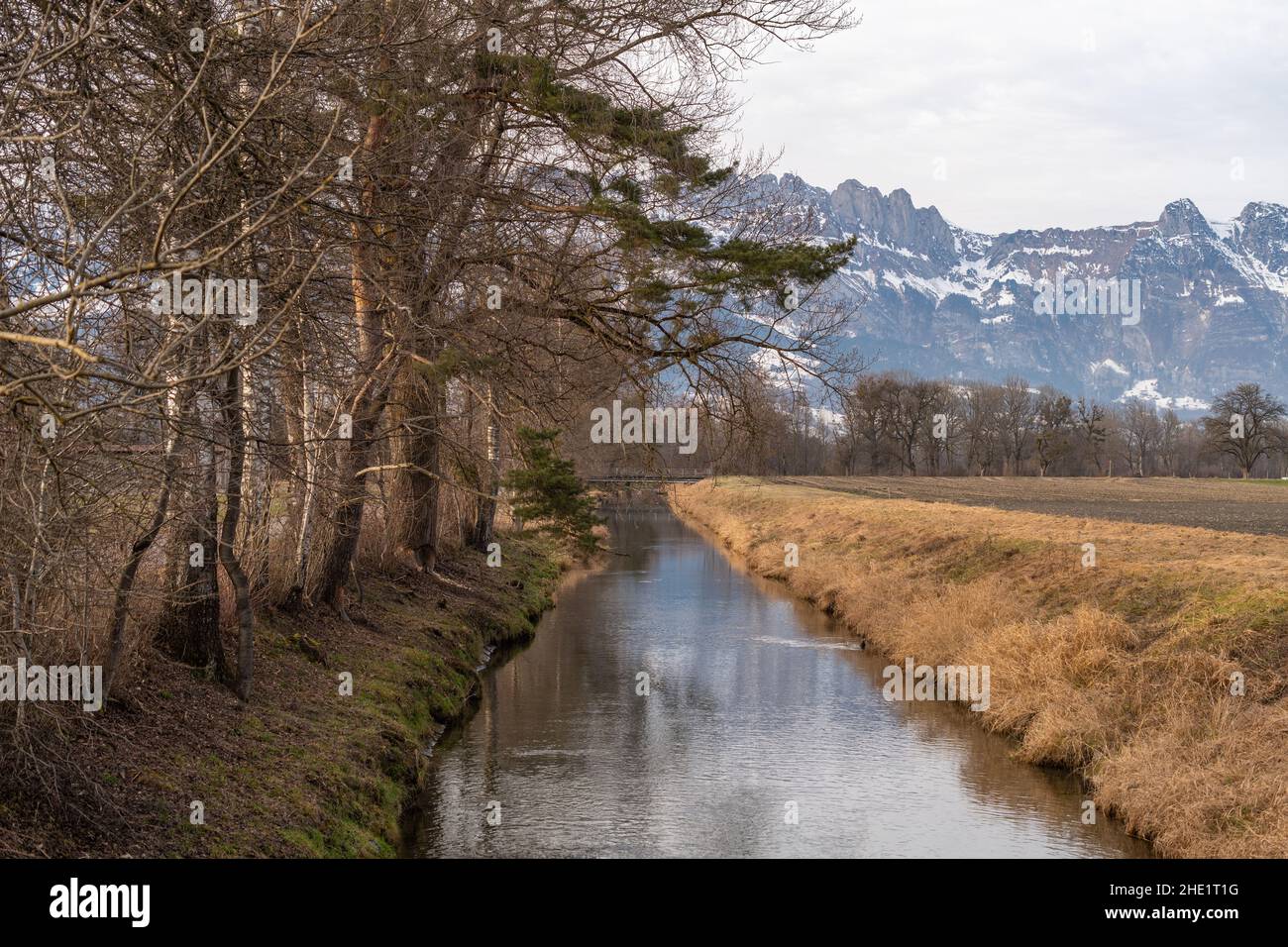 Vaduz, Liechtenstein, December 23, 2021 Little river flows along some ...