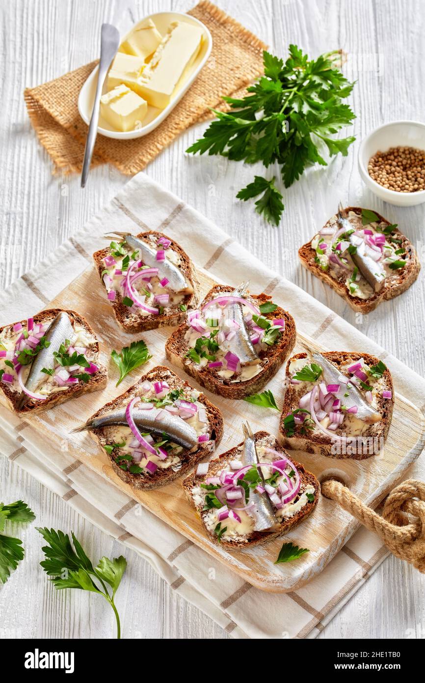 pickled sprat open sandwiches with butter and red onion on rye bread ...