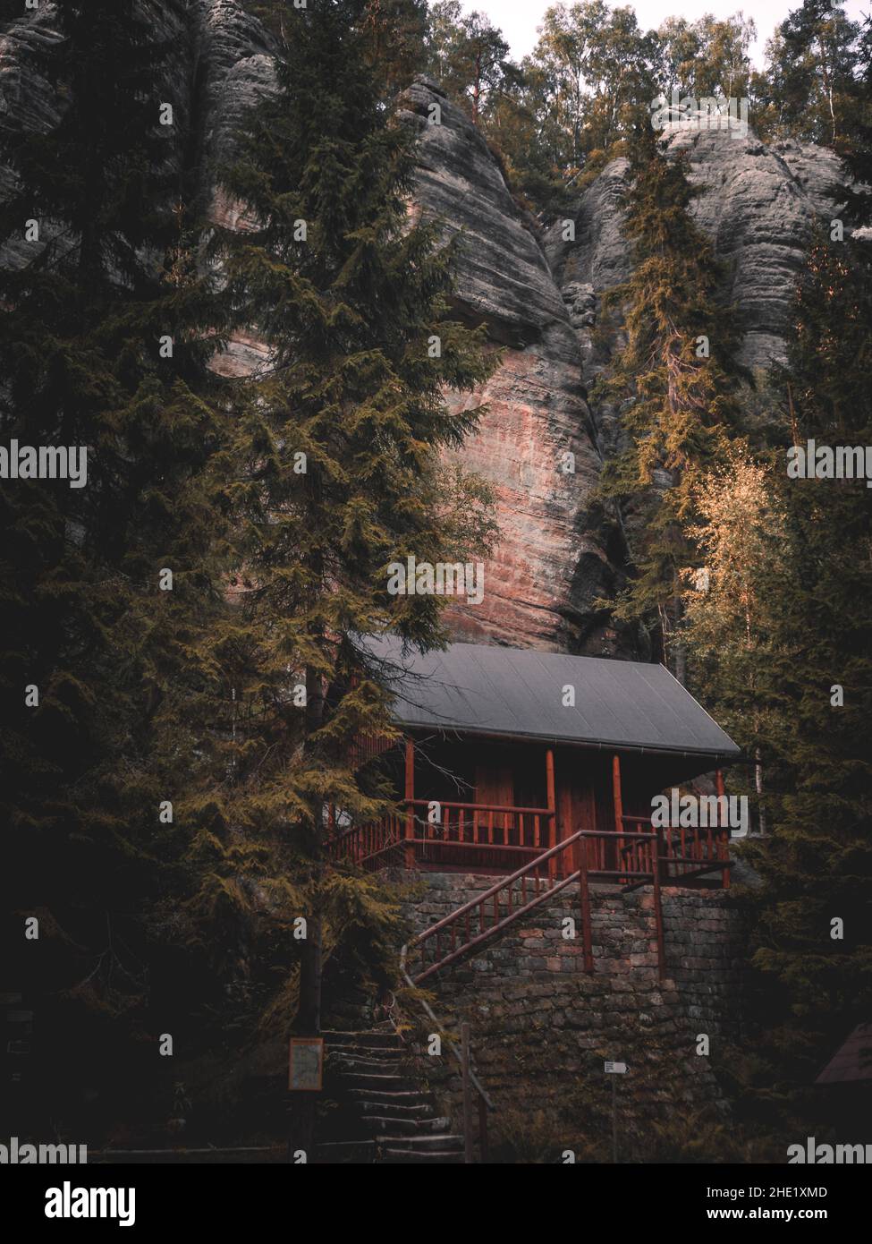 Vertical shot of a small red hut in the woods Stock Photo - Alamy