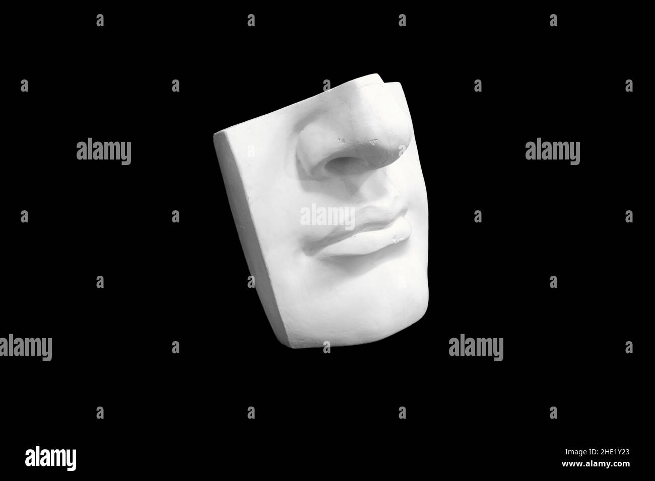 Fragment of plaster sculpture of a human face isolated on black ...