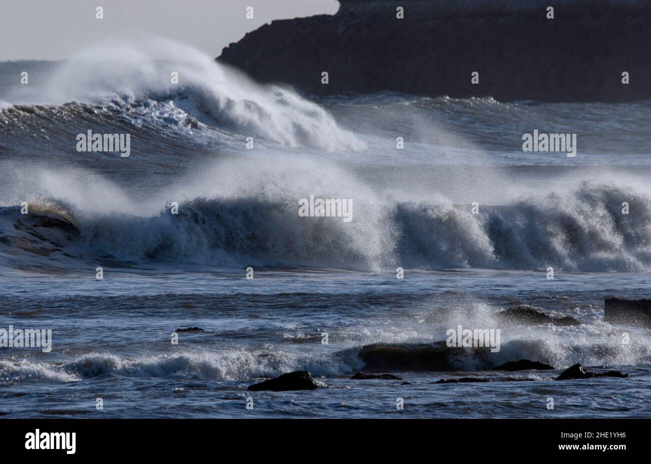 Breakers roll in from the North Sea after a winters gale. Waves such as ...