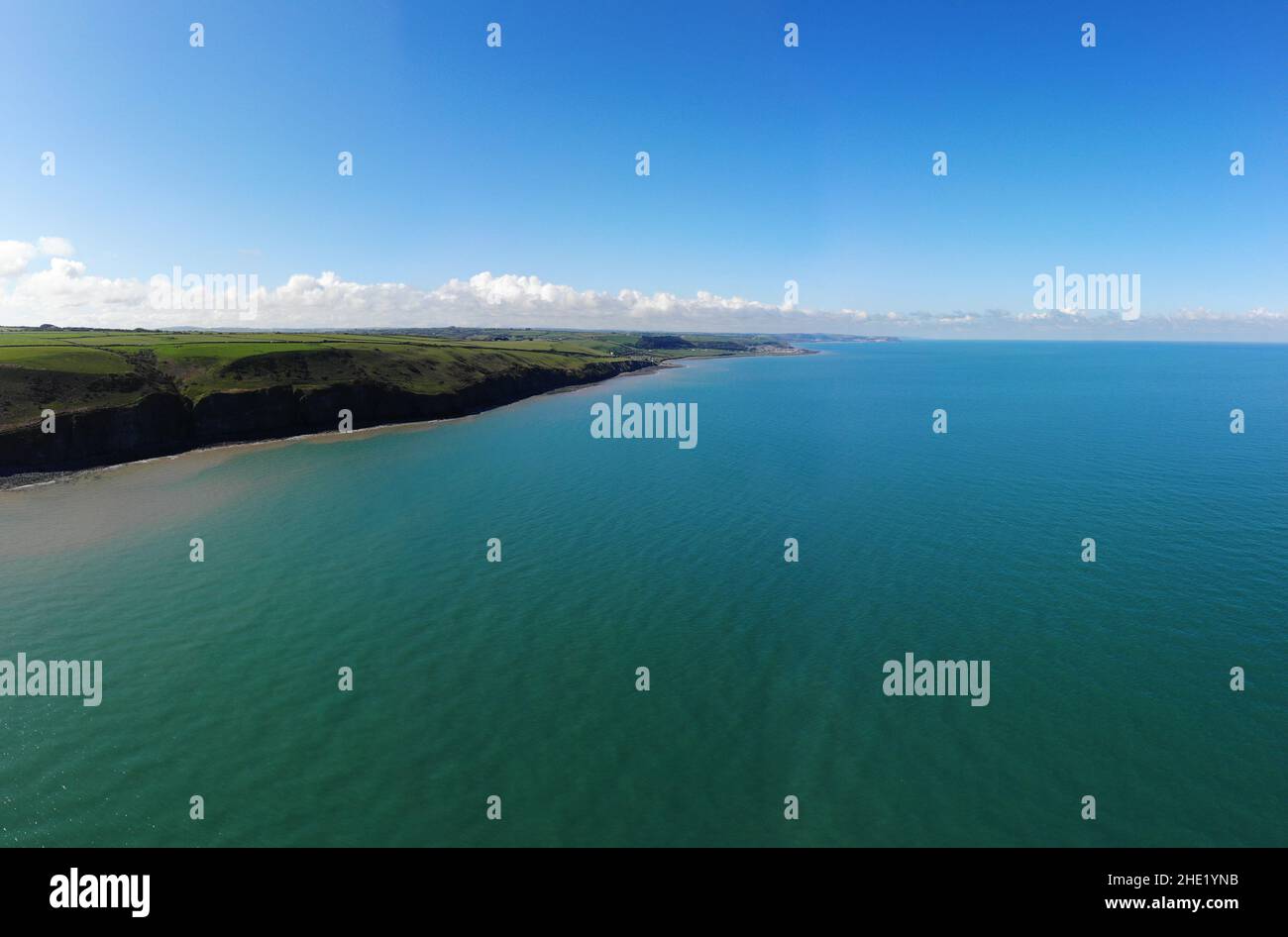 Aerial image of the Welsh coast and cliff in Llannon, Ceredigion. Blue ...