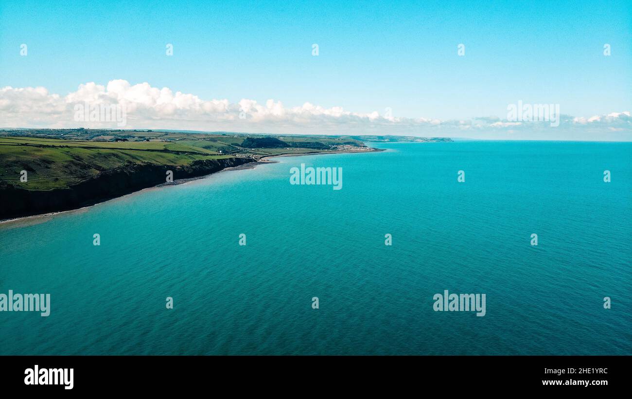 Aerial image of the Welsh coast and cliff in Llannon, Ceredigion. Blue ...