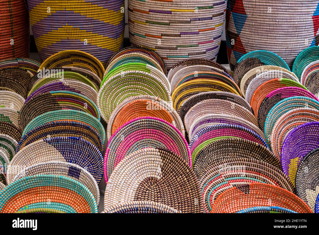 Many different goods like artful handmade colorful baskets are sold at ...
