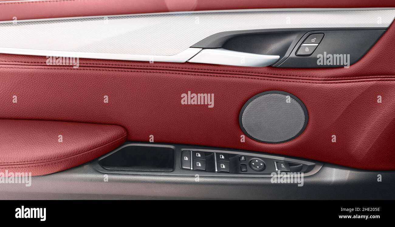 Car door handle inside the luxury modern car with red leather. Switch ...