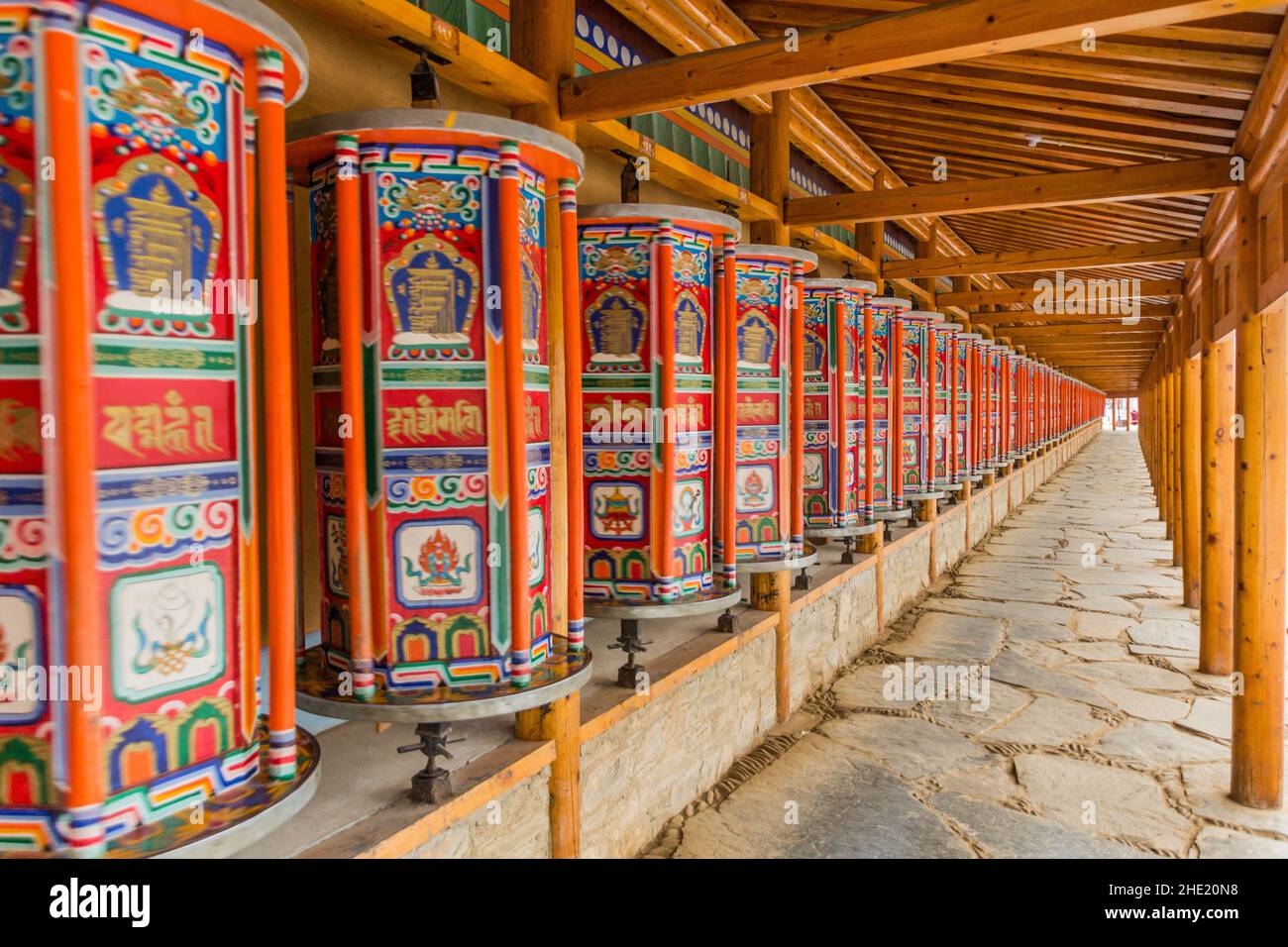 Row of praying wheels around Labrang Monastery in Xiahe town, Gansu ...