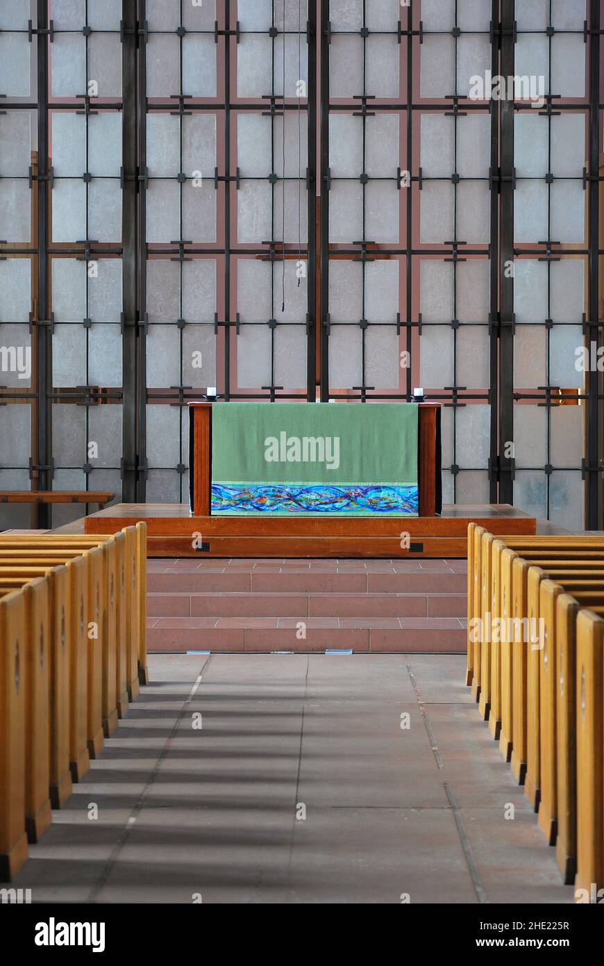 Vertical shot of the altar and benches in the church with beautiful ...